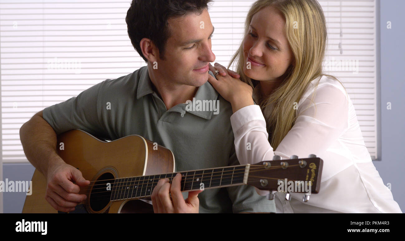 Boyfriend playing guitar for his girlfriend Stock Photo - Alamy