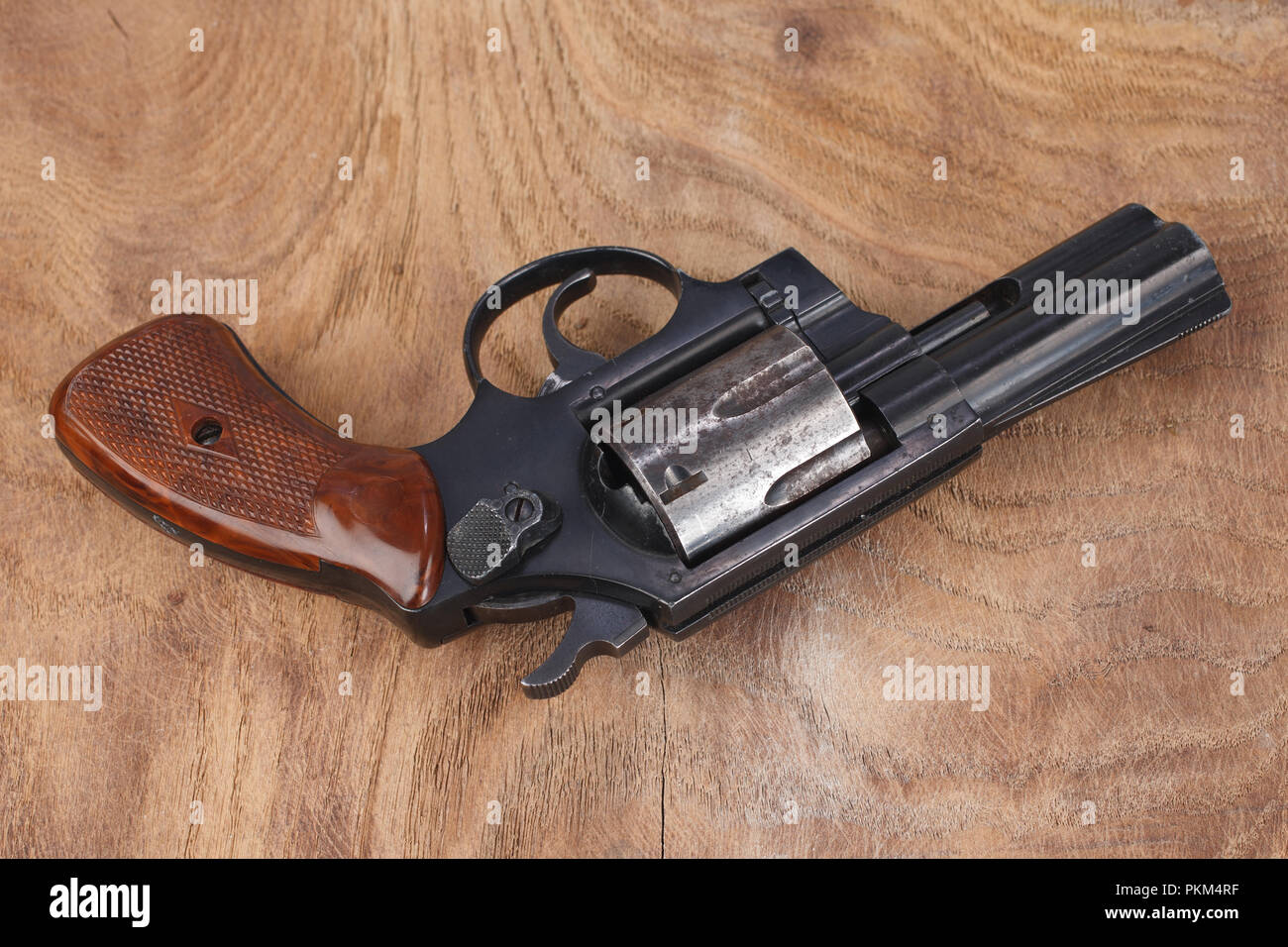 Revolver with ammunition on the wooden background Stock Photo - Alamy