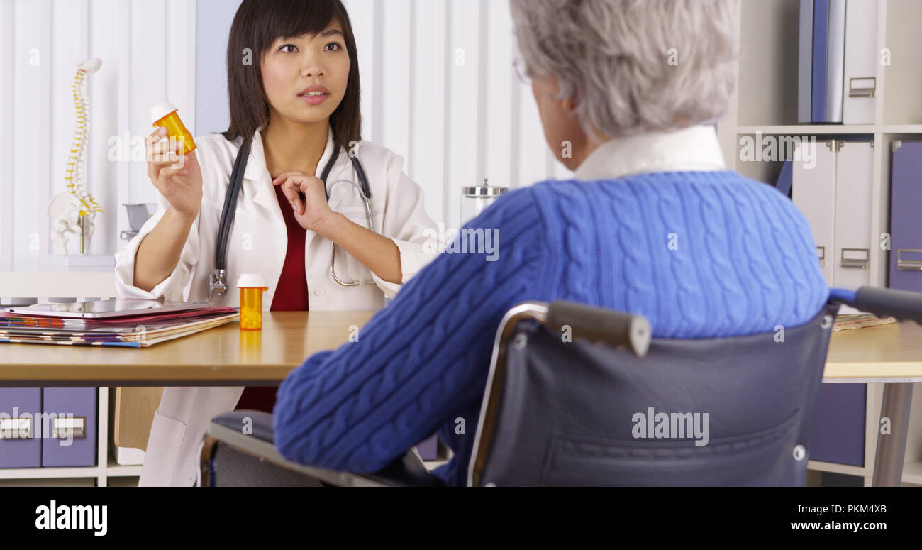 Chinese doctor talking about medication to elderly patient Stock Photo ...