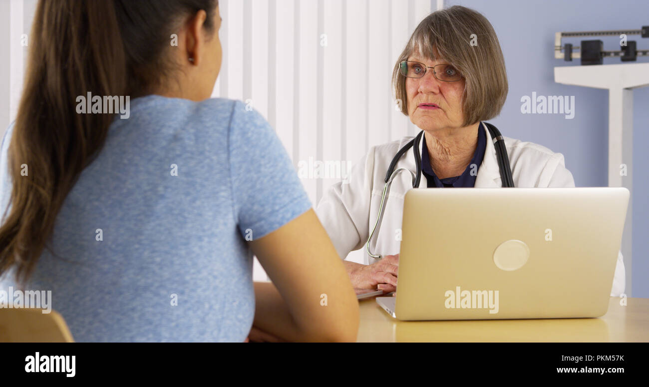 Senior doctor advising mexican hi-res stock photography and images - Alamy