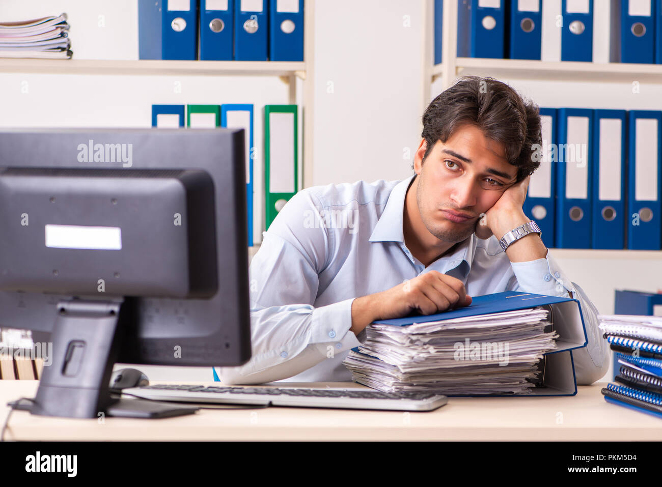 Overloaded busy employee with too much work and paperwork Stock Photo ...