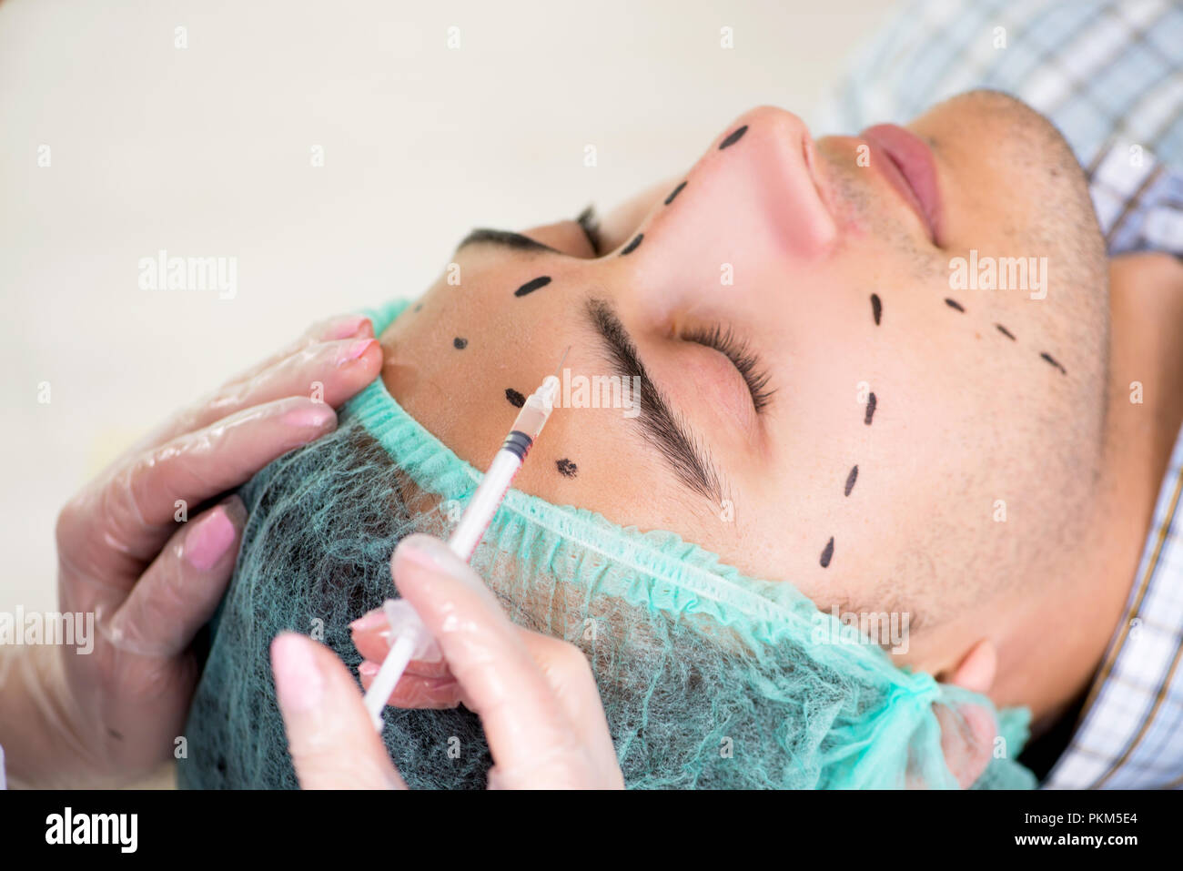 Plastic surgeon preparing for operation on man face Stock Photo - Alamy