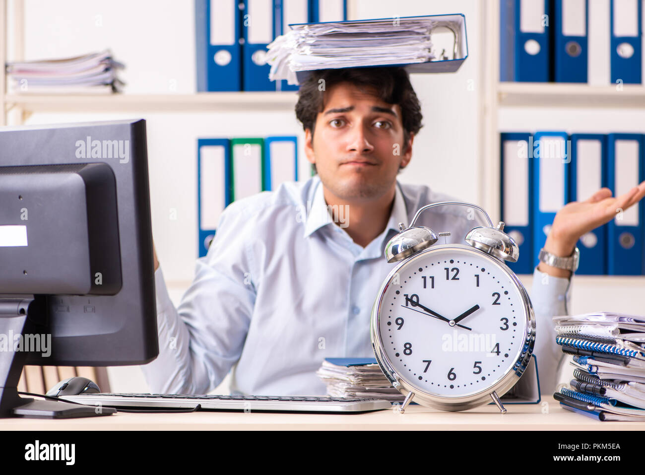 Overloaded busy employee with too much work and paperwork Stock Photo ...