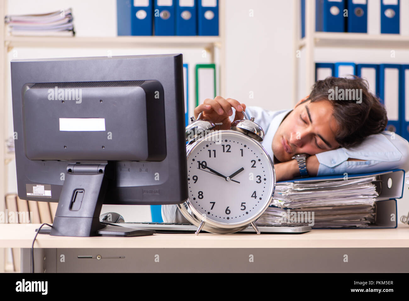 Overloaded busy employee with too much work and paperwork Stock Photo ...