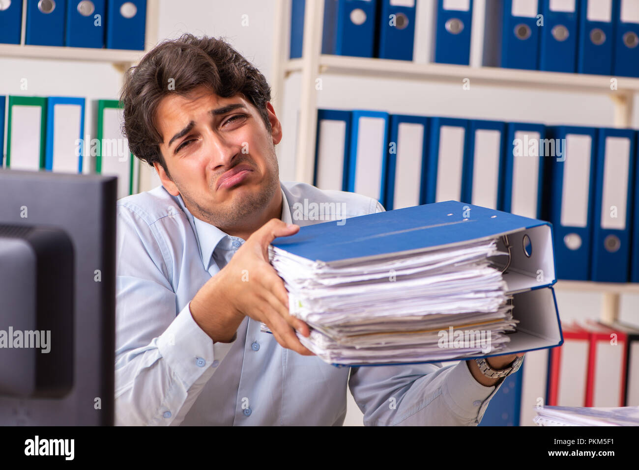 Overloaded busy employee with too much work and paperwork Stock Photo ...