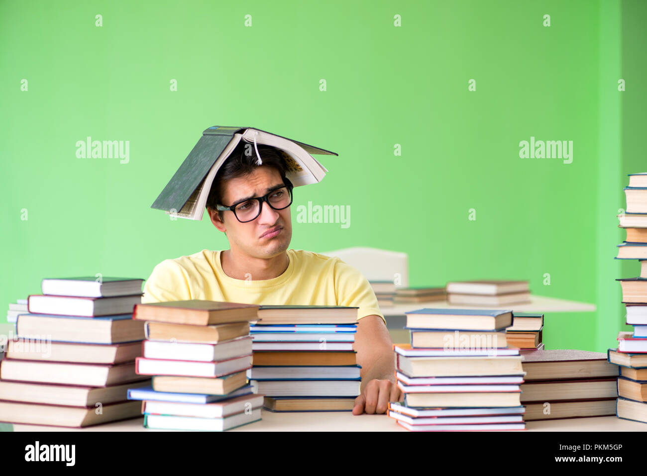 Student with too many books to read before exam Stock Photo - Alamy