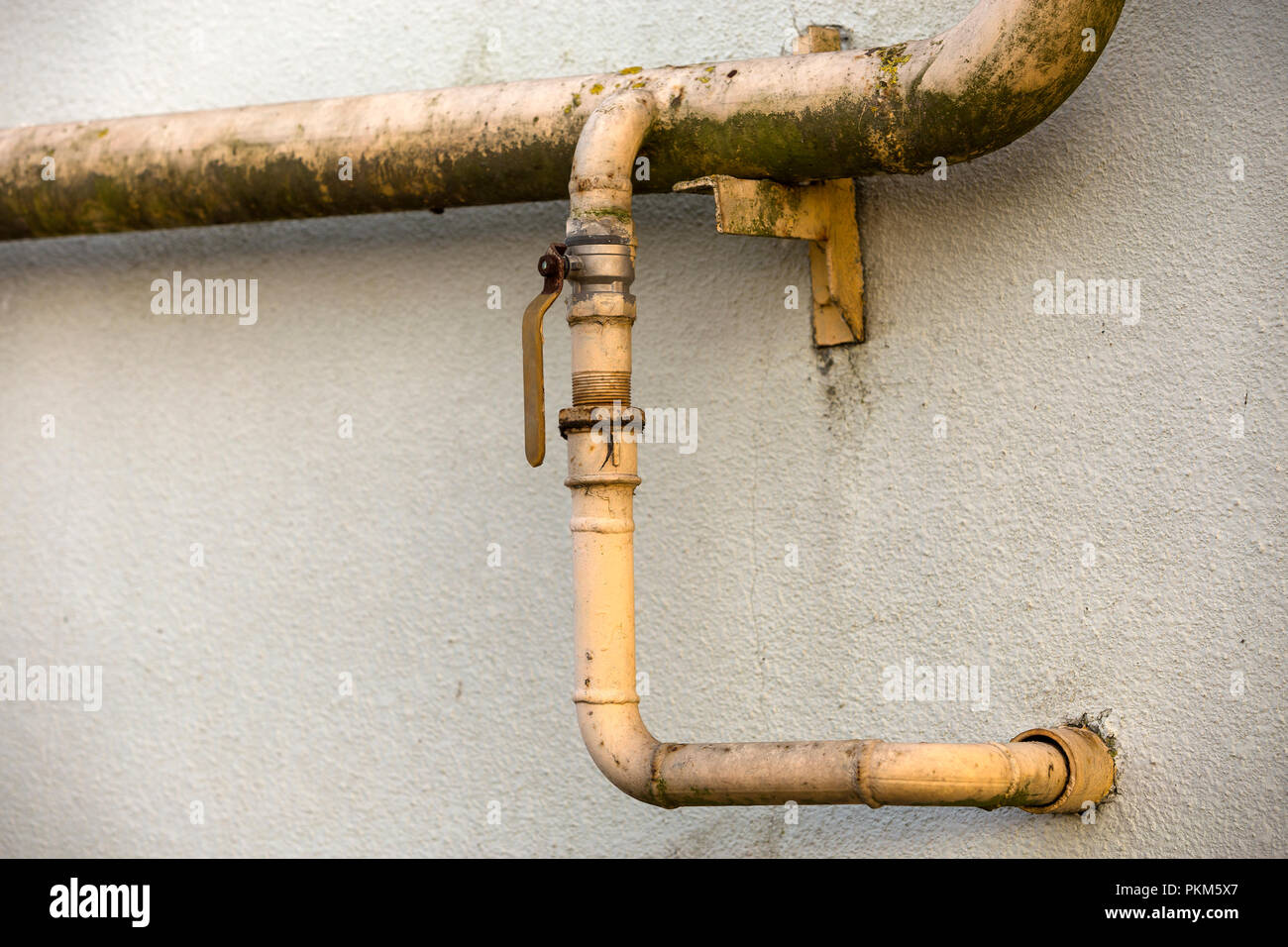Close-up detail of old dirty painted yellow natural gas pipes with ...