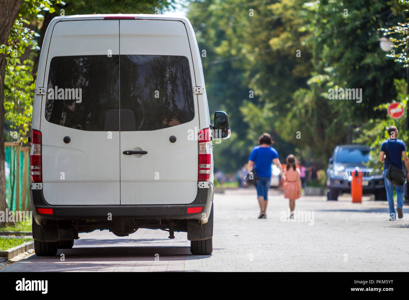 Back view of white passenger medium size commercial luxury minibus van ...