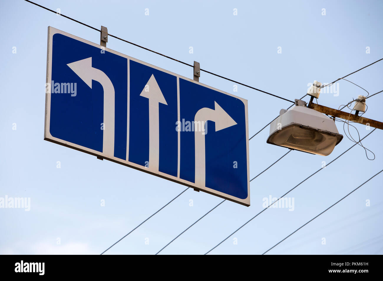 Close-up of road sign attached to trolley line near the lamp high over ...