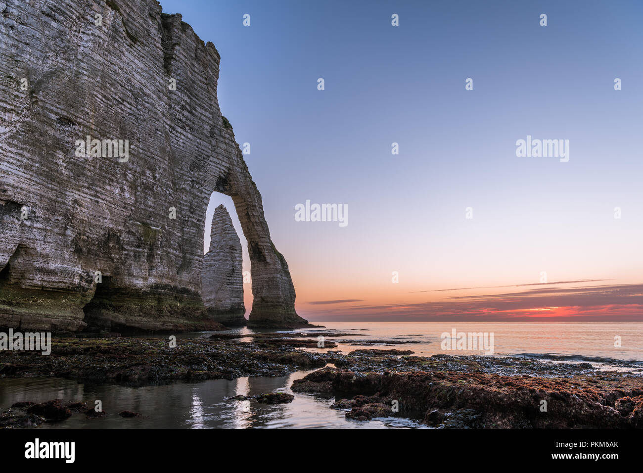Chalk cliffs of Etretat (Normandy France) with the natural arch Porte d ...