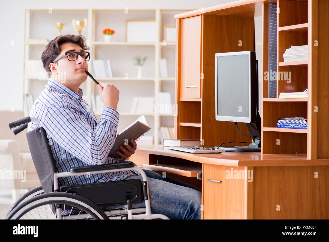 Disabled student studying at home on wheelchair Stock Photo - Alamy