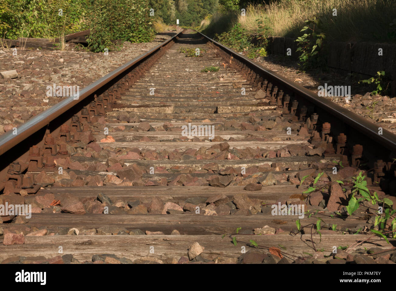 single train track on lost places trainstation Stock Photo - Alamy