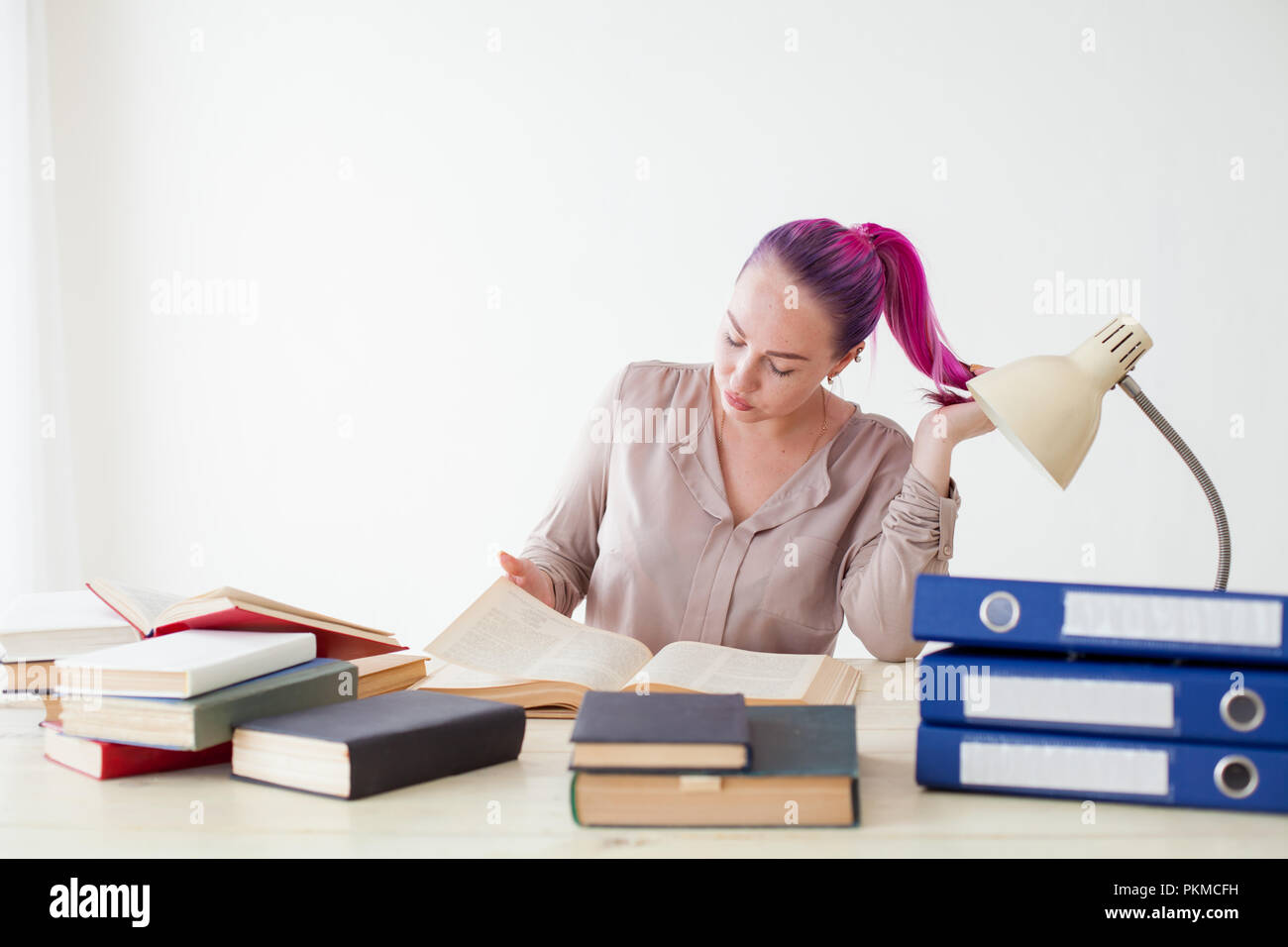woman tired work in the Office and reading books Stock Photo - Alamy