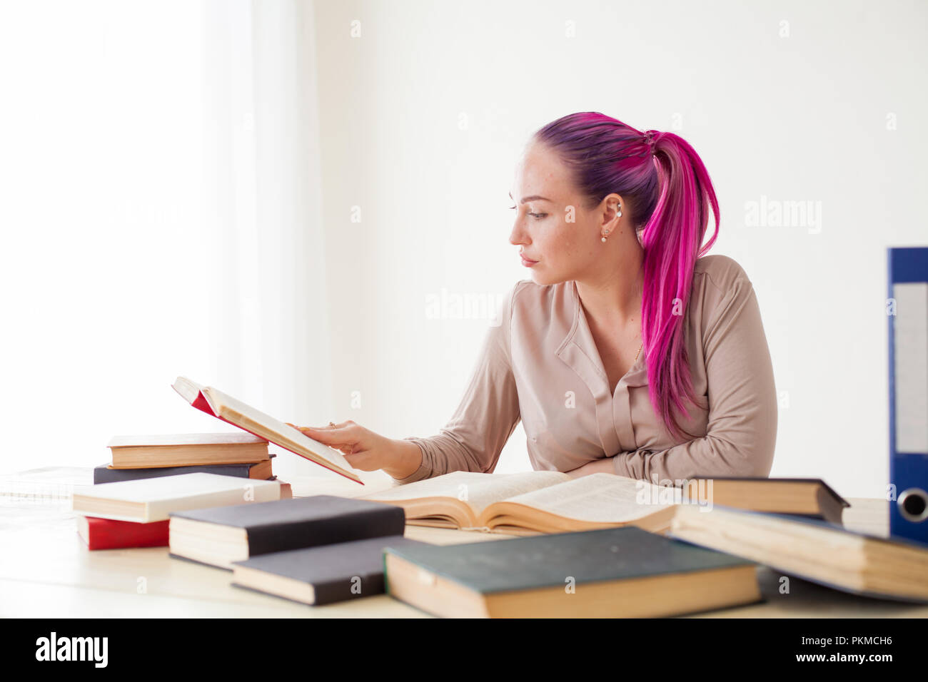 woman tired work in the Office and reading books Stock Photo - Alamy