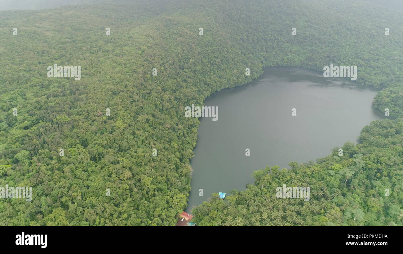Aerial view of lake Bulusan in the mountains with green rain forest ...
