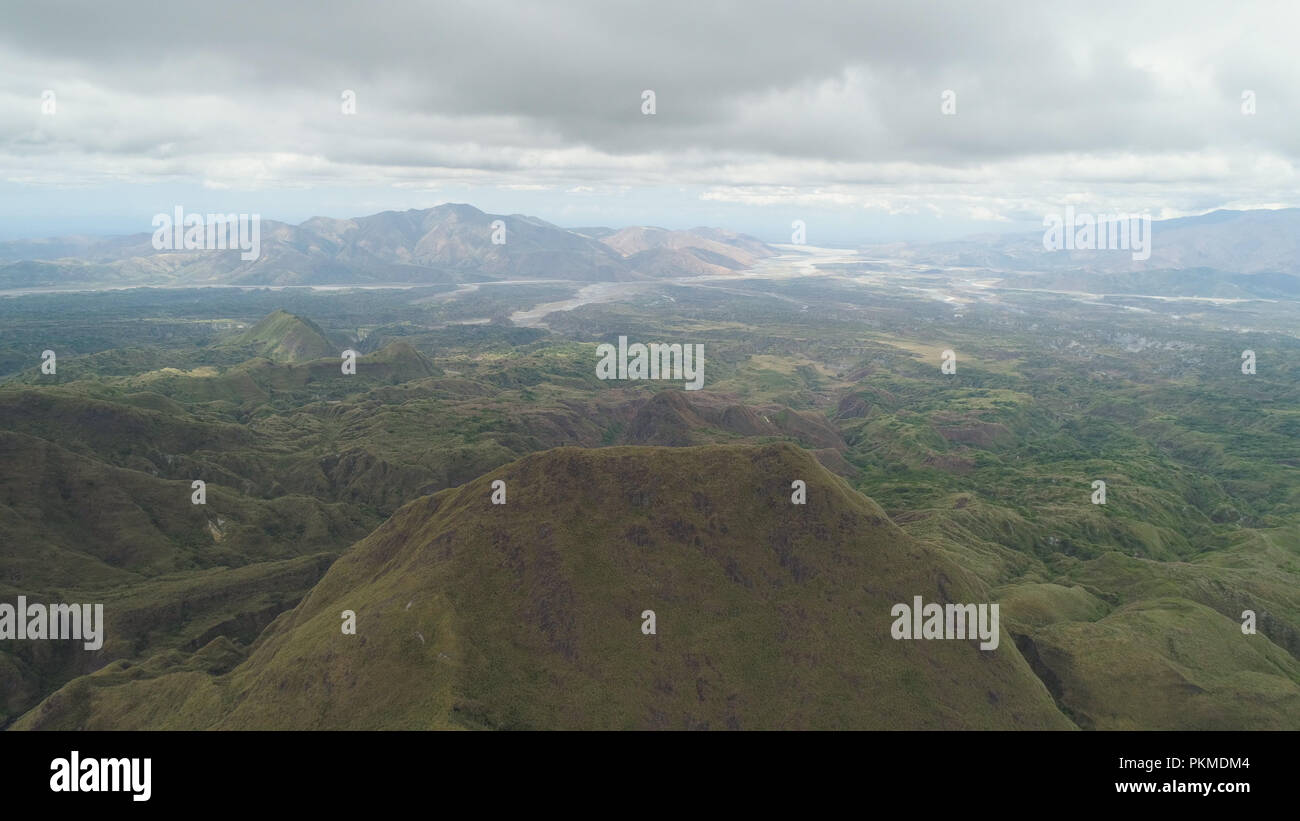 Aerial view of mountains covered with green vegetation, trees in ...