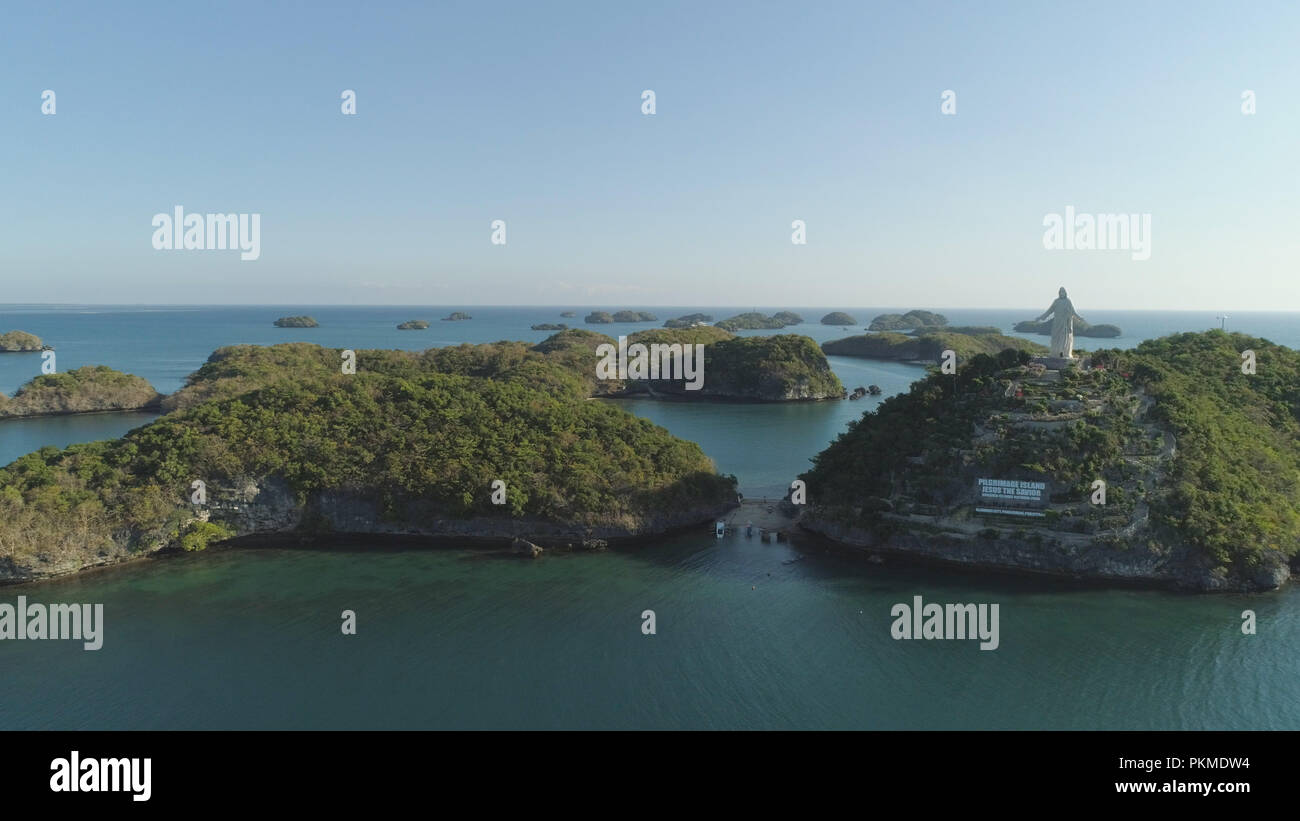 Small islands in Hundred Islands National Park with statue of Jesus ...