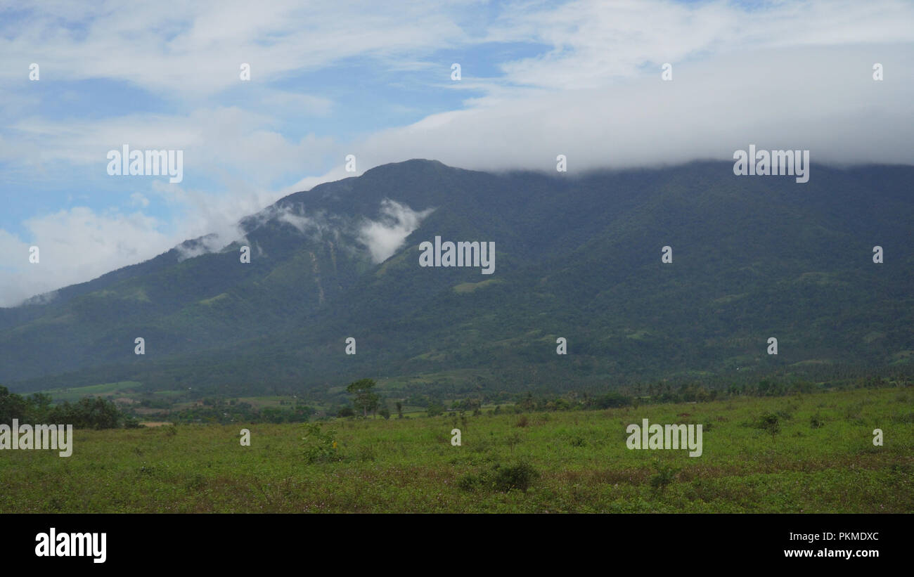 Mountain valley near mount Isarog. Mount with green tropical rainforest ...