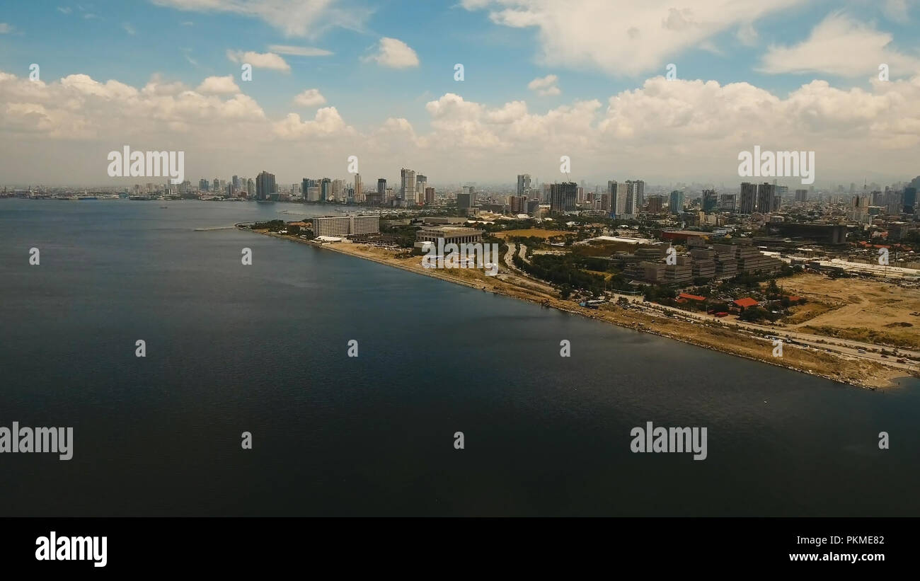 Aerial view of Manila city. Fly over city with skyscrapers and ...