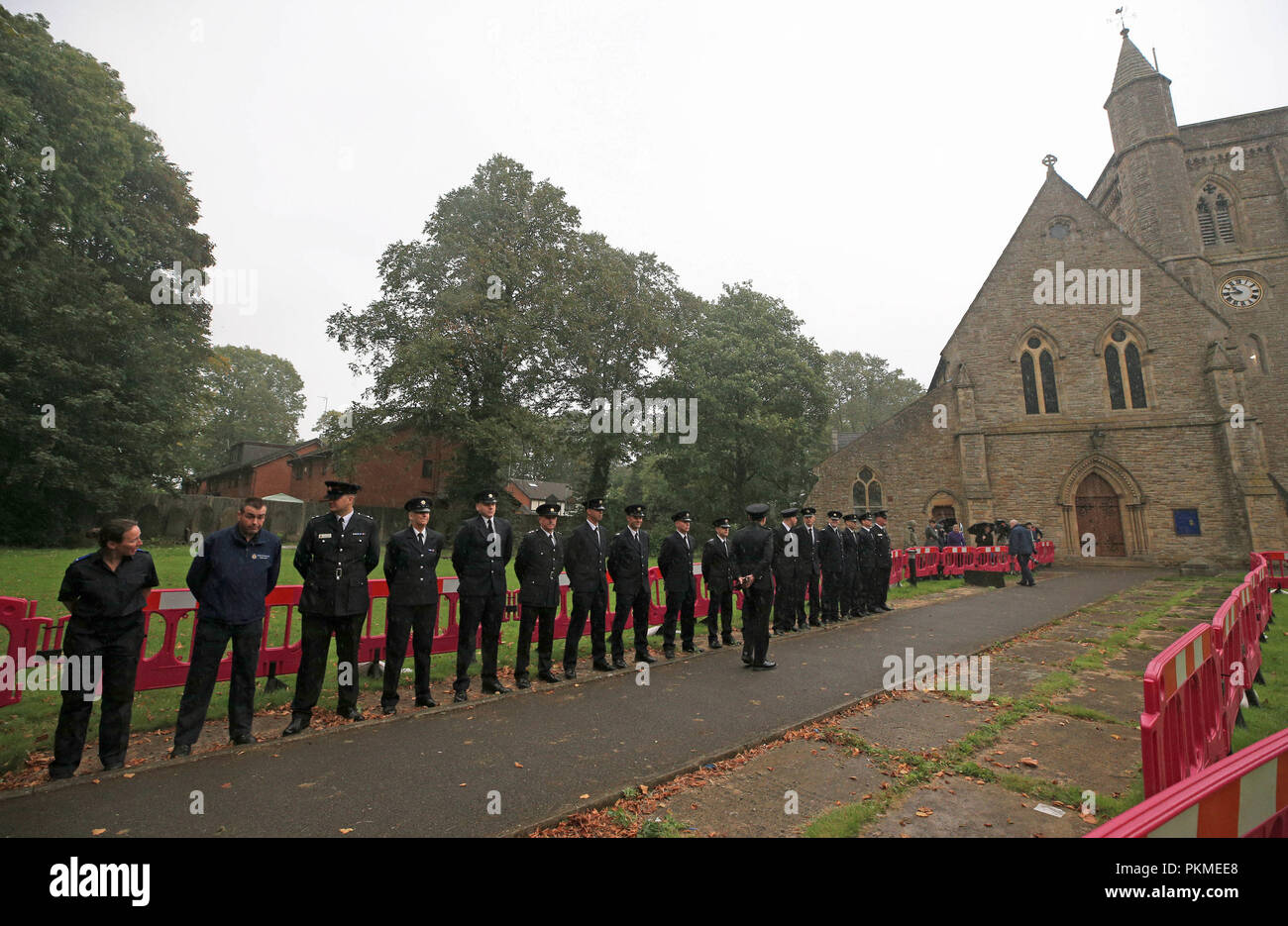 Emergency services personnel line up outside St Paul's Church in ...