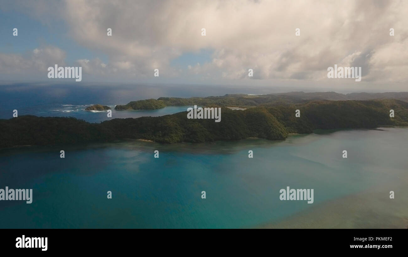 Aerial view:Tropical island with beach, mountains and the rainforest ...