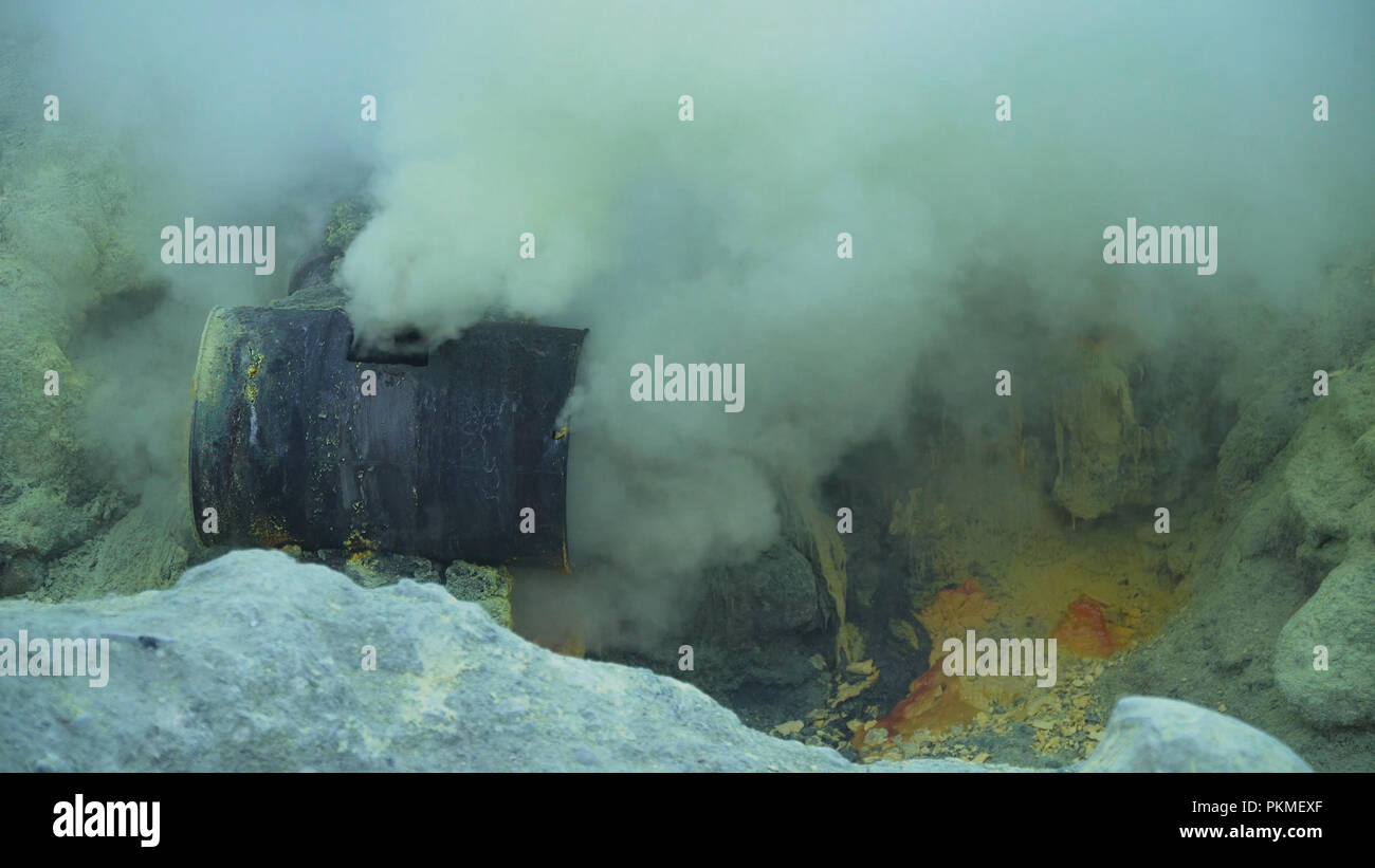 Extraction of sulfur in the crater of a volcano. Sulfur gas, smoke ...