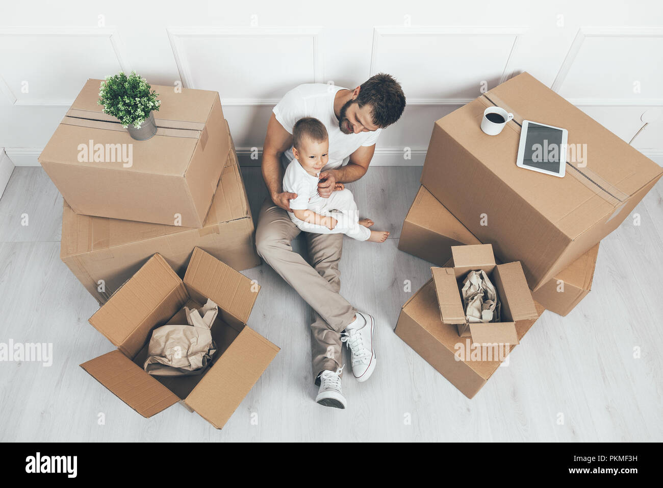 Top view. Father and son moving into their new home Stock Photo - Alamy