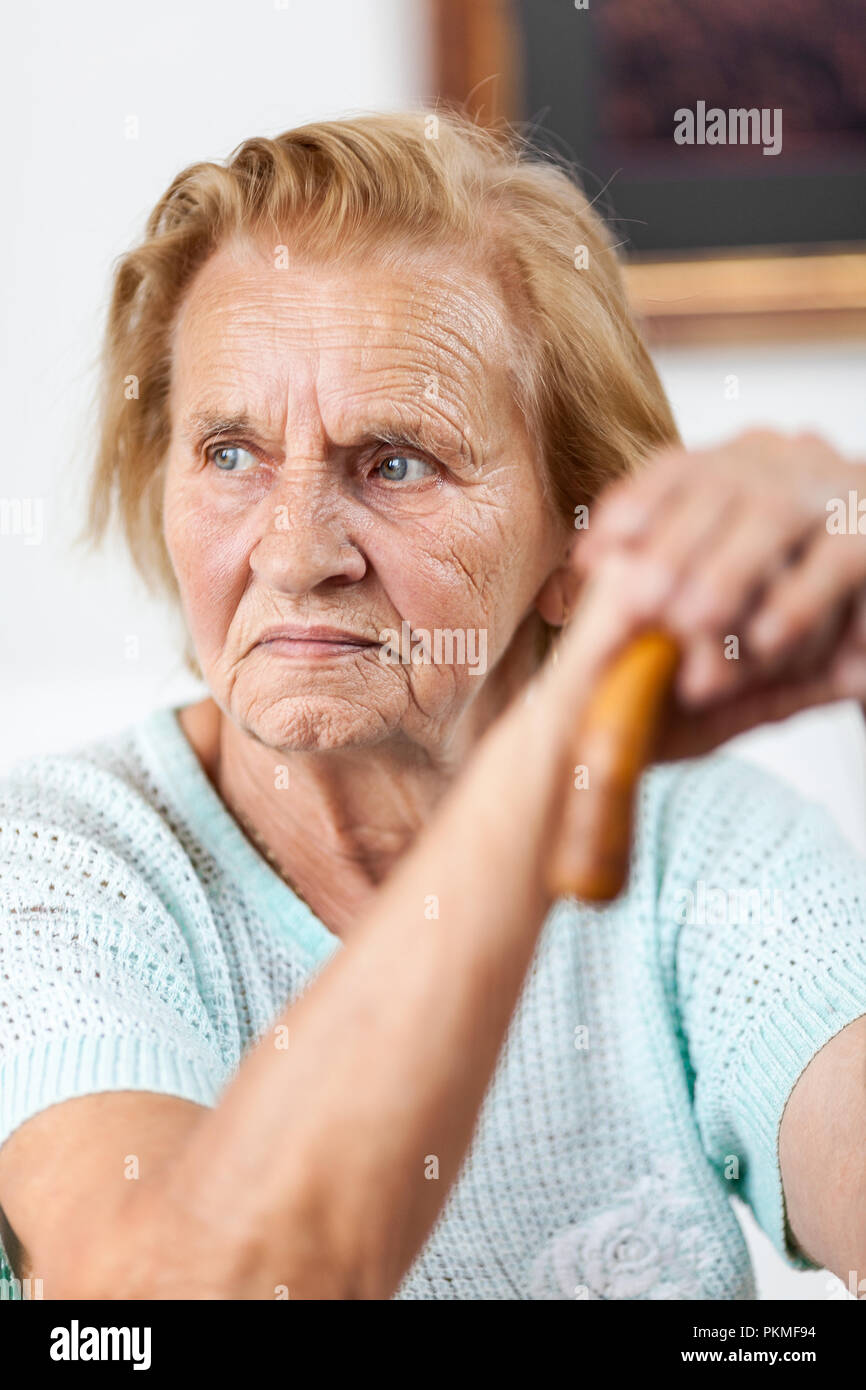 Elderly woman in the 80s with a walking stick Stock Photo - Alamy