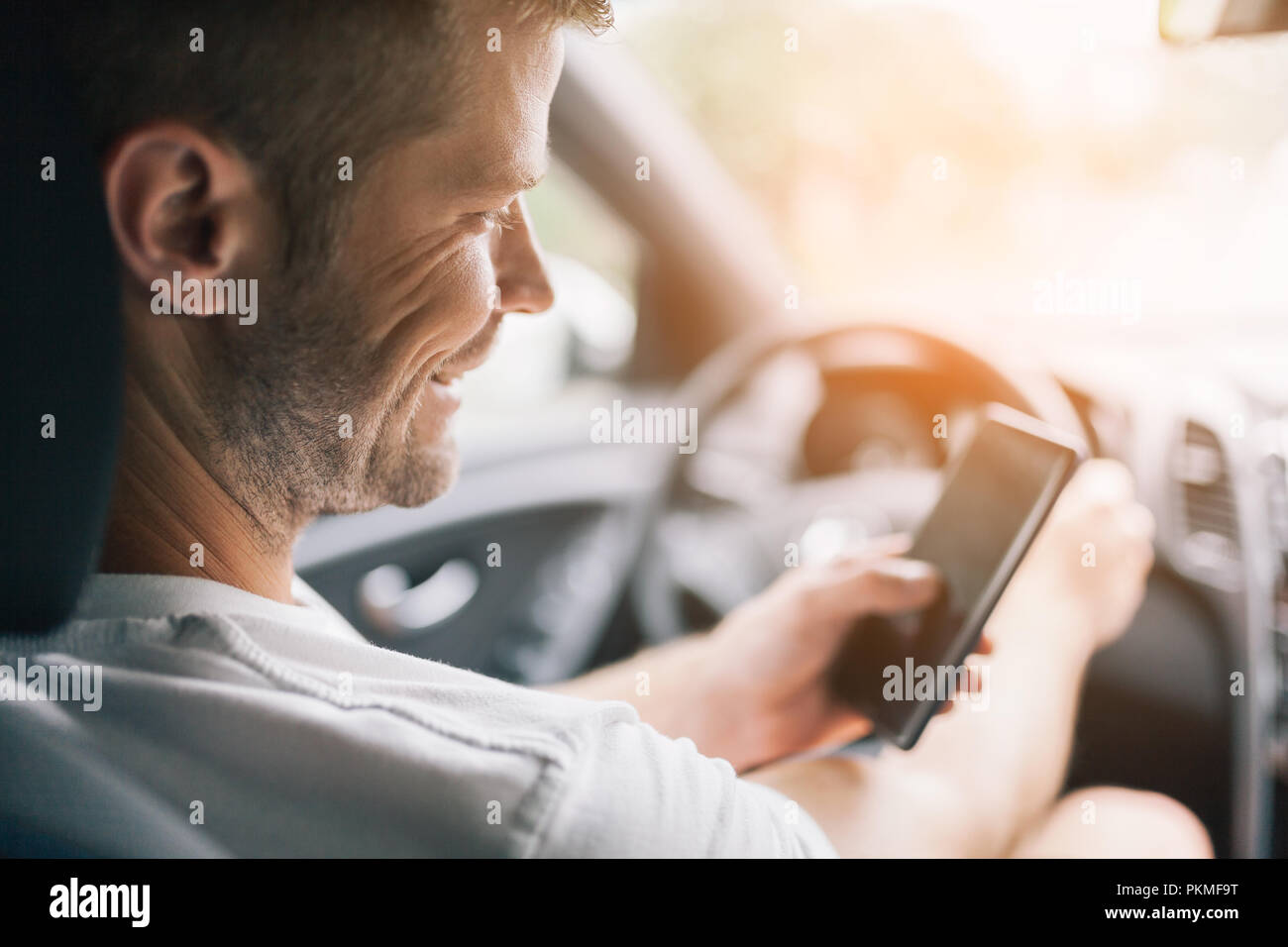 Careless driver using his mobile phone whilst driving a car Stock Photo ...
