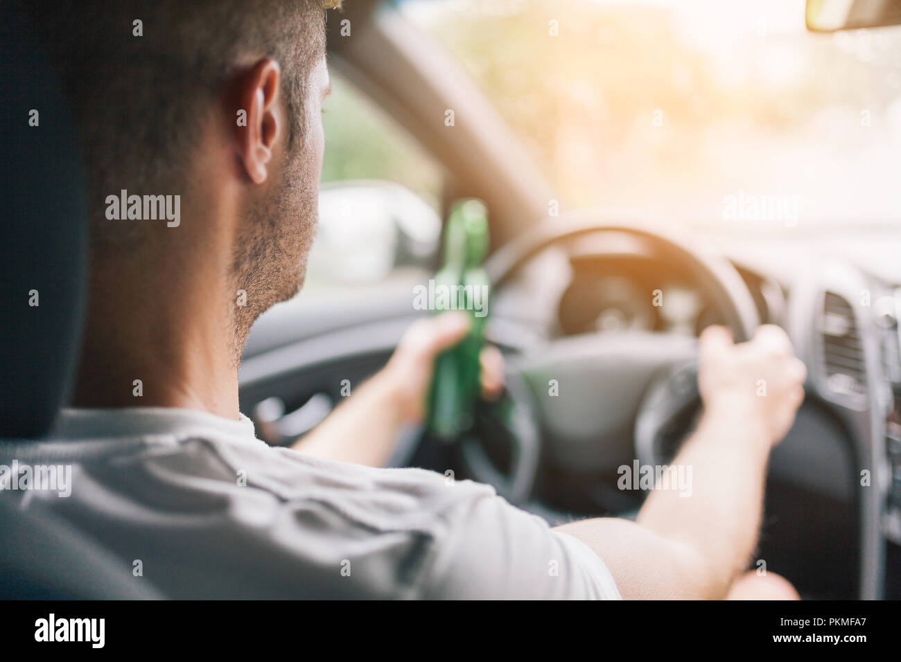 Drunk driver drinking behind the steering wheel of a car Stock Photo ...