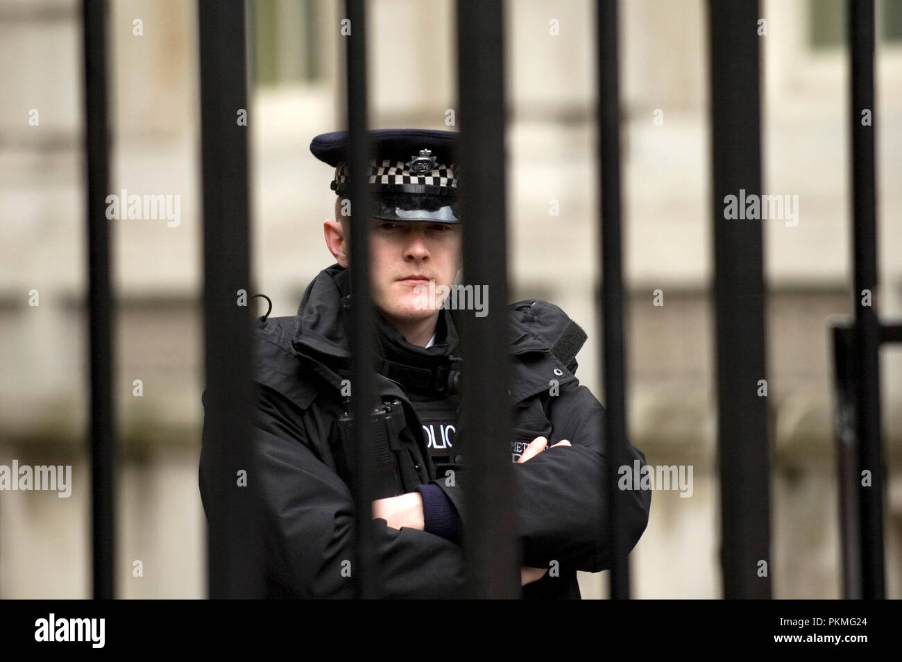 Police officer behind security fence on Downing Street, London, England ...