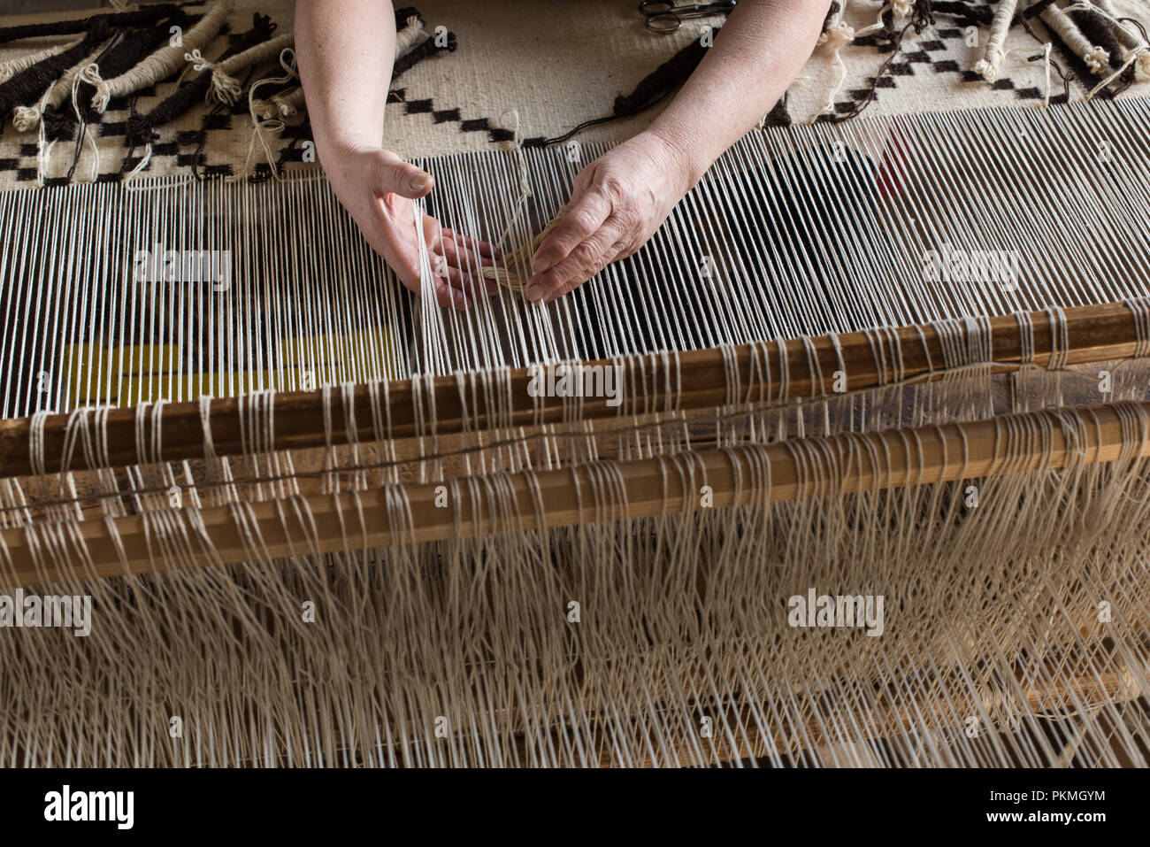 Weaving loom and shuttle on the warp. Weaving background and sample ...