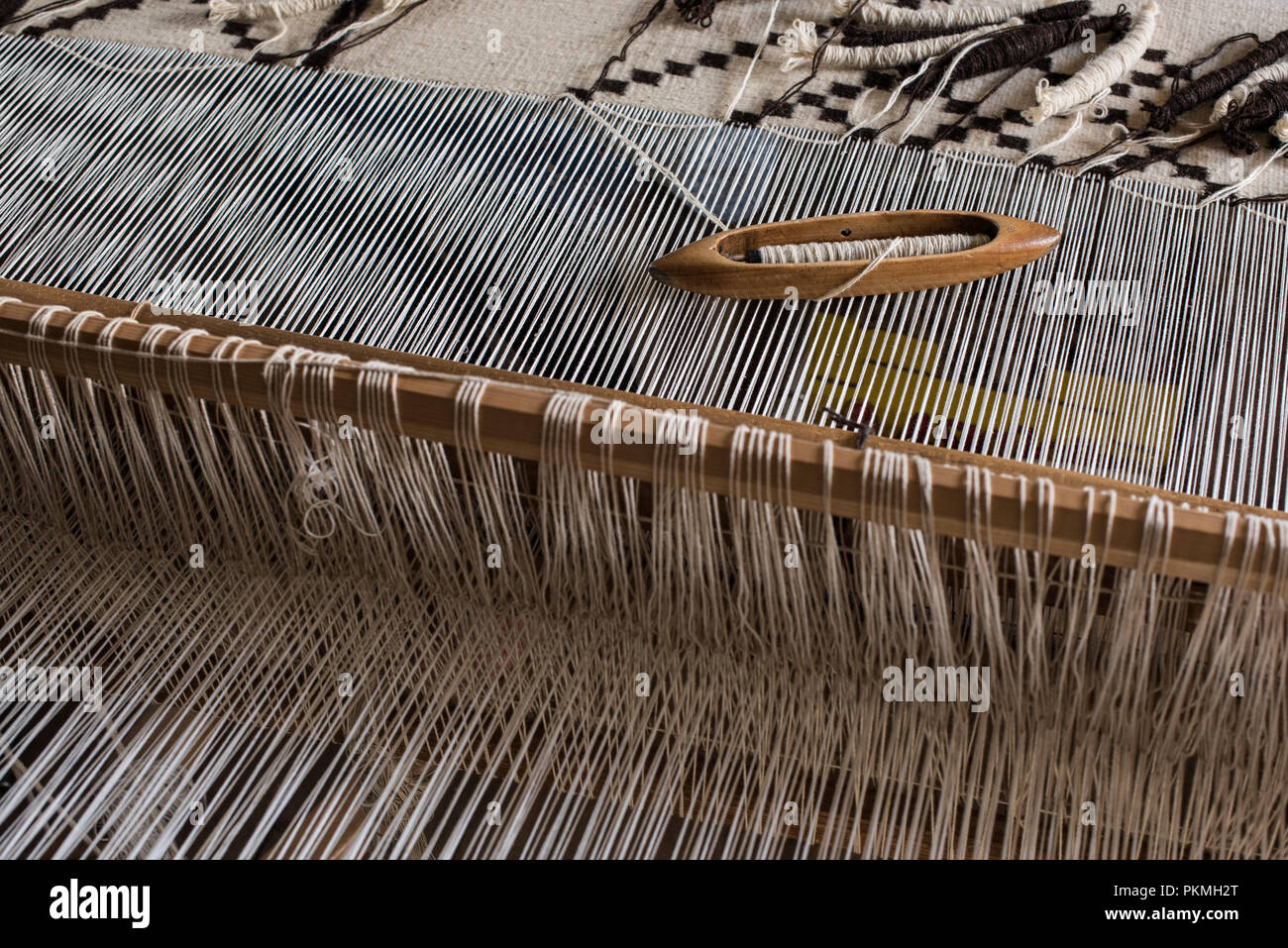 Weaving loom and shuttle on the warp. Weaving background and sample ...