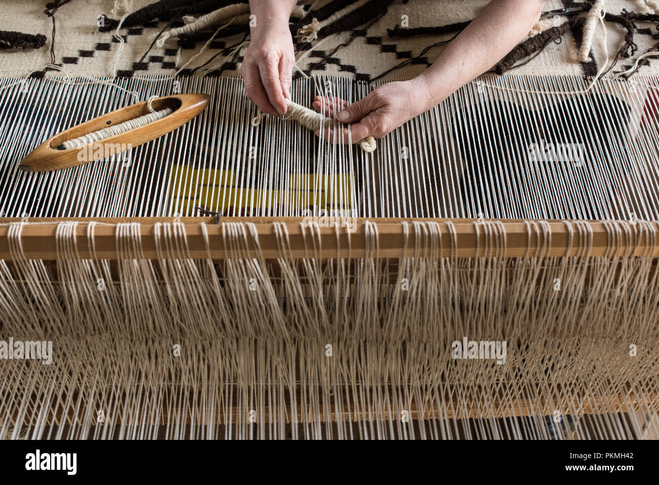 Weaving loom and shuttle on the warp. Weaving background and sample ...