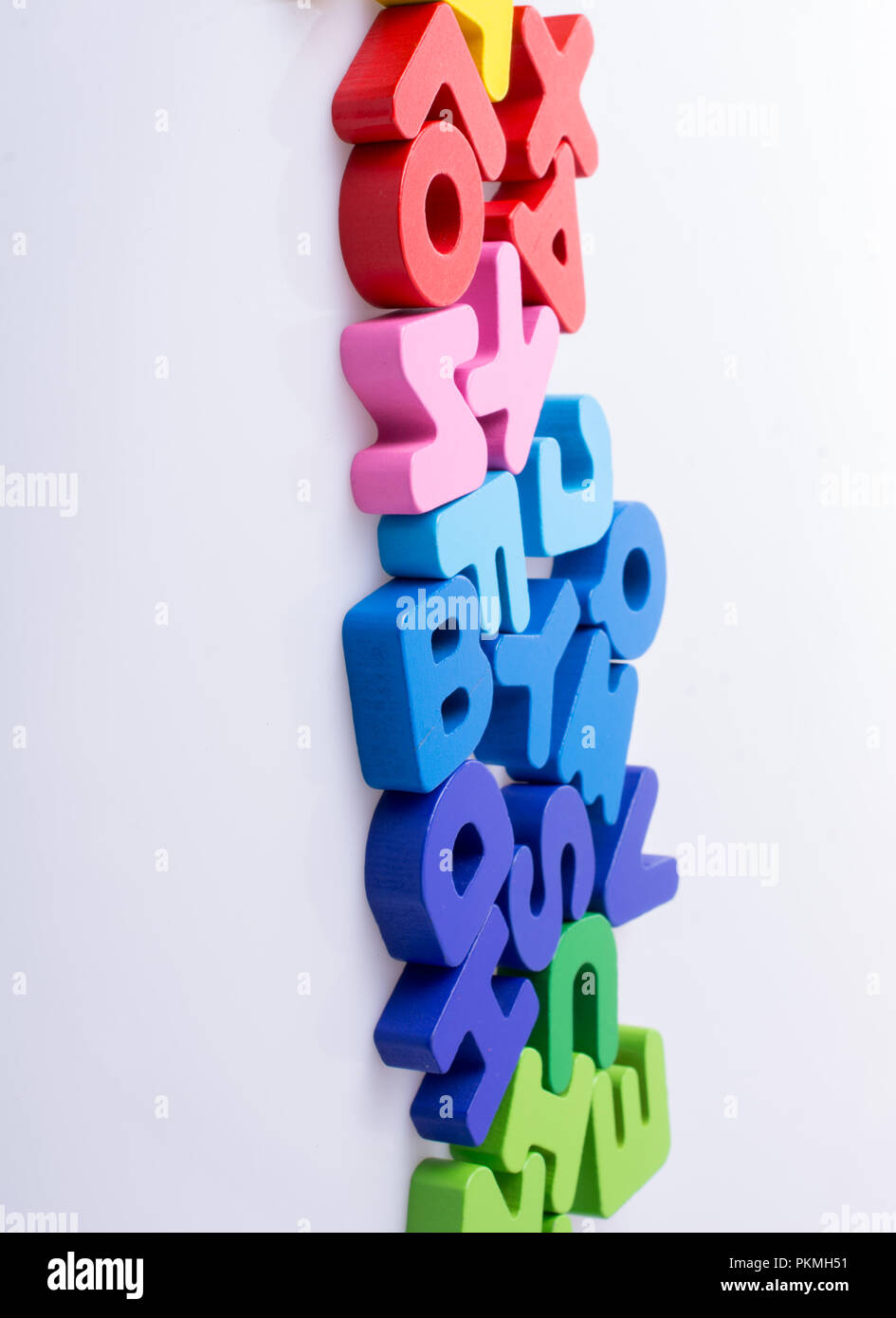 Colorful alphabet letter blocks scattered randomly on white background ...