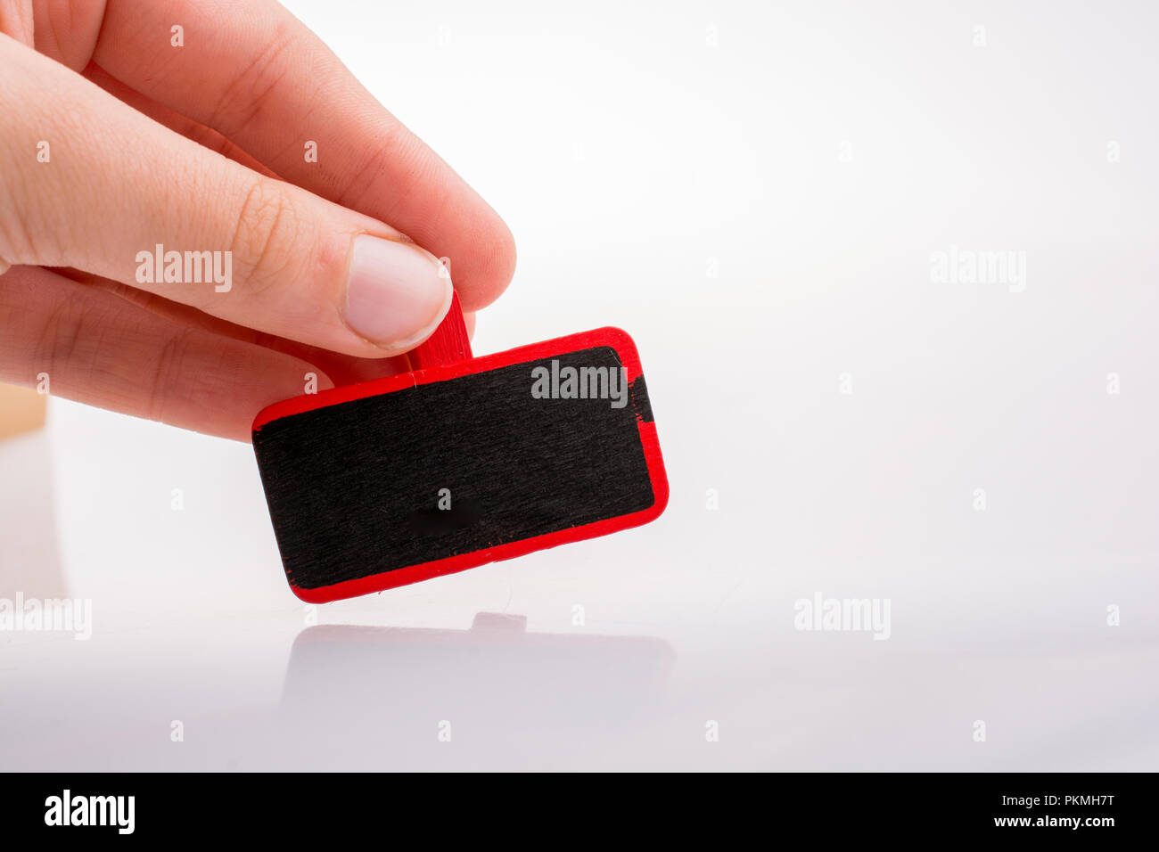 Hand holding a mini size notice board made of wood Stock Photo - Alamy