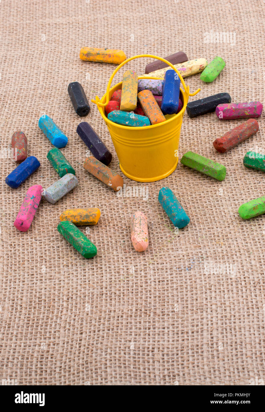 Crayons of various color in a bucket on a canvas Stock Photo - Alamy
