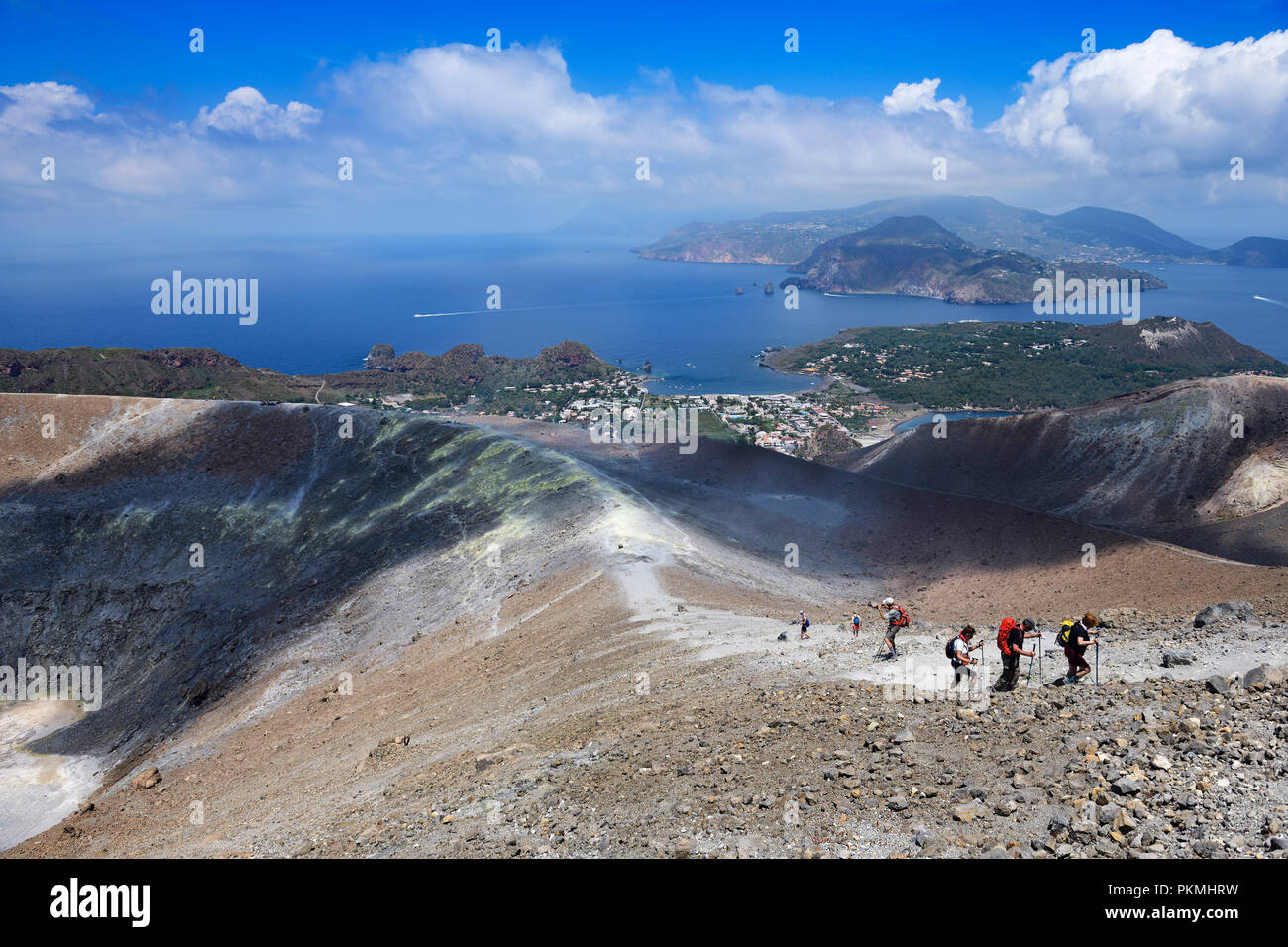 Hikers on the edge of the great crater overlooking Lipari, Gran Cratere ...