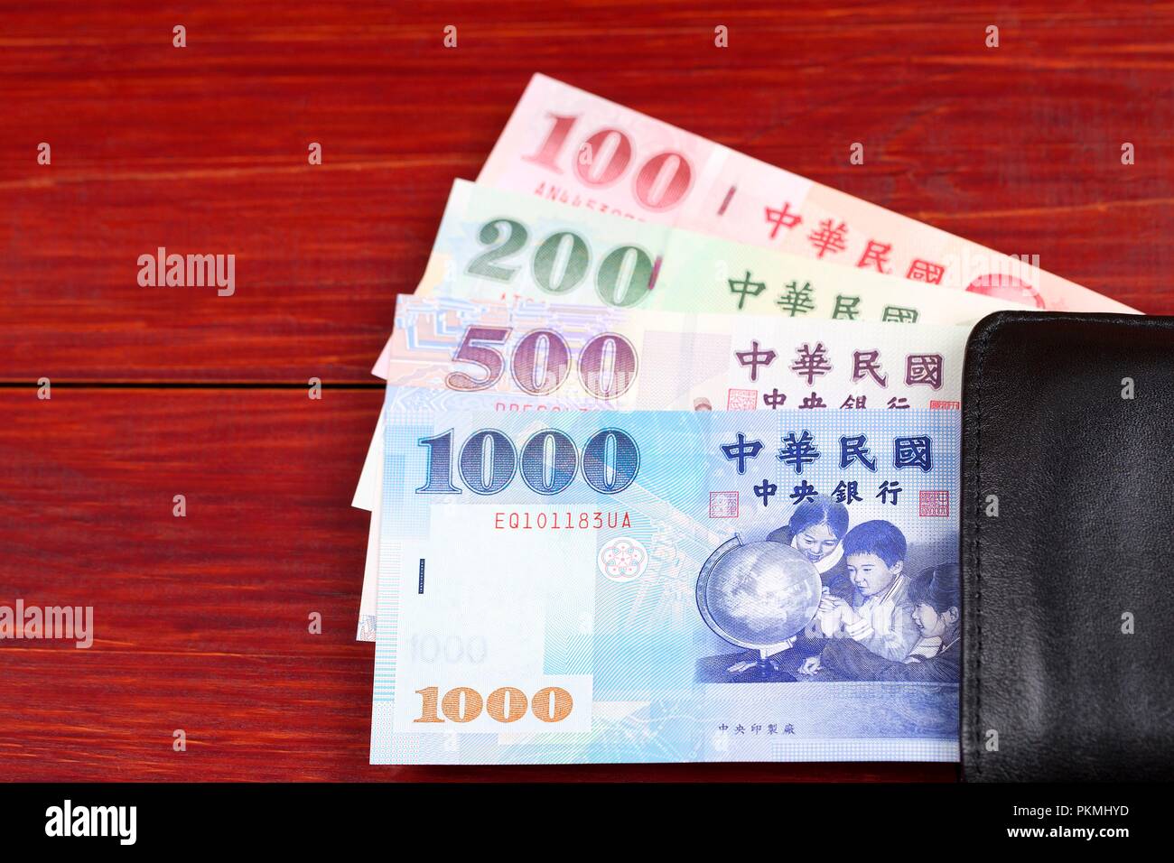 Money from Taiwan in the black wallet Stock Photo - Alamy