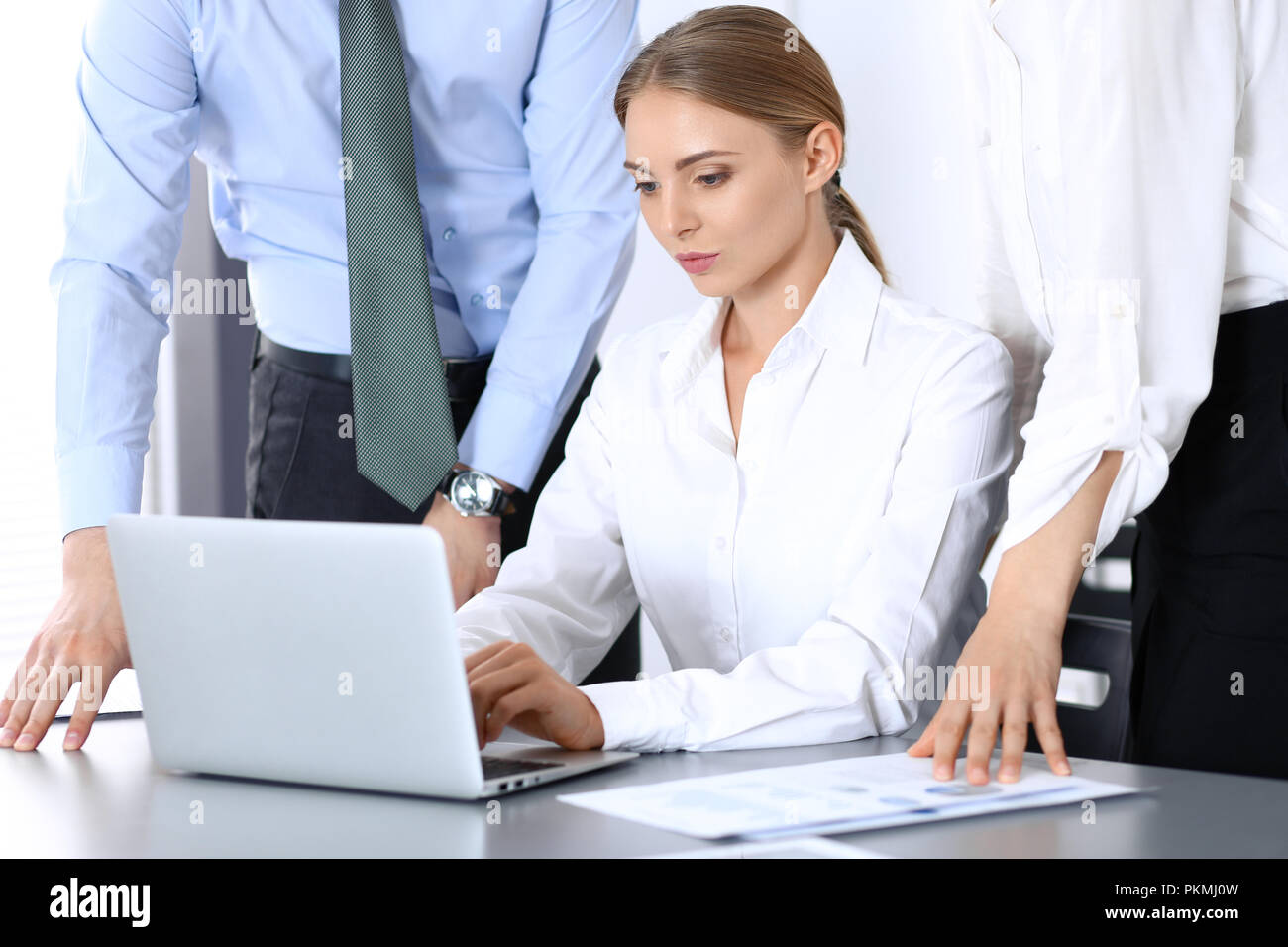 Group of business people using laptop computer in office. Meeting and ...