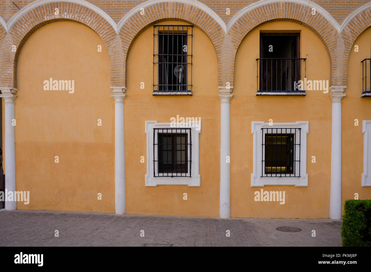 Yellow arches above the balcony window in Seville, Spain, Europe Stock ...