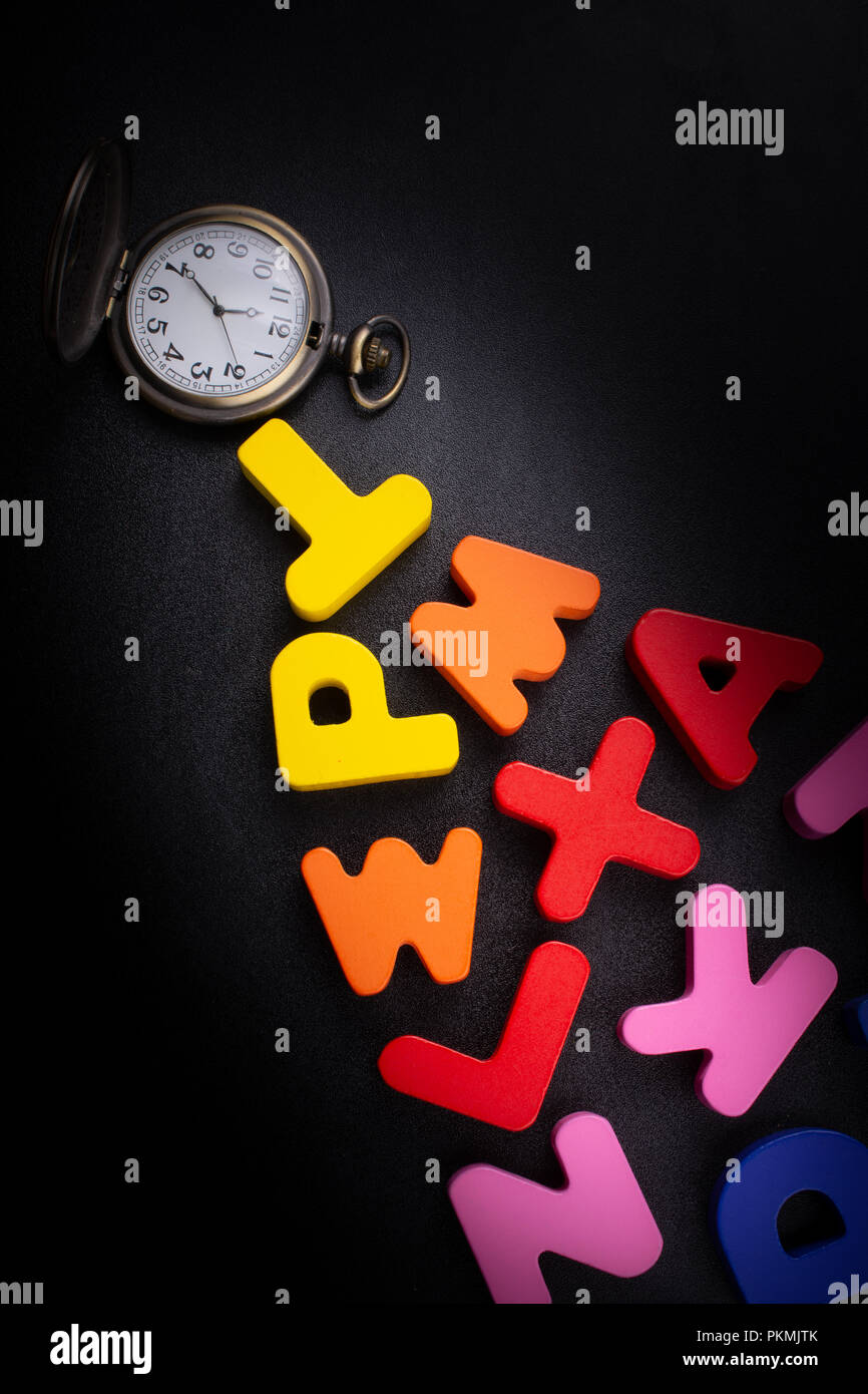 Pocket watch and colorful Letters of Alphabet made of wood Stock Photo ...