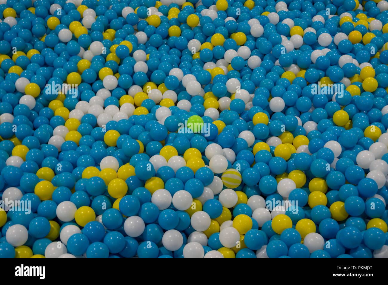 background with colorful plastic balls, red and yellow middle blue ...