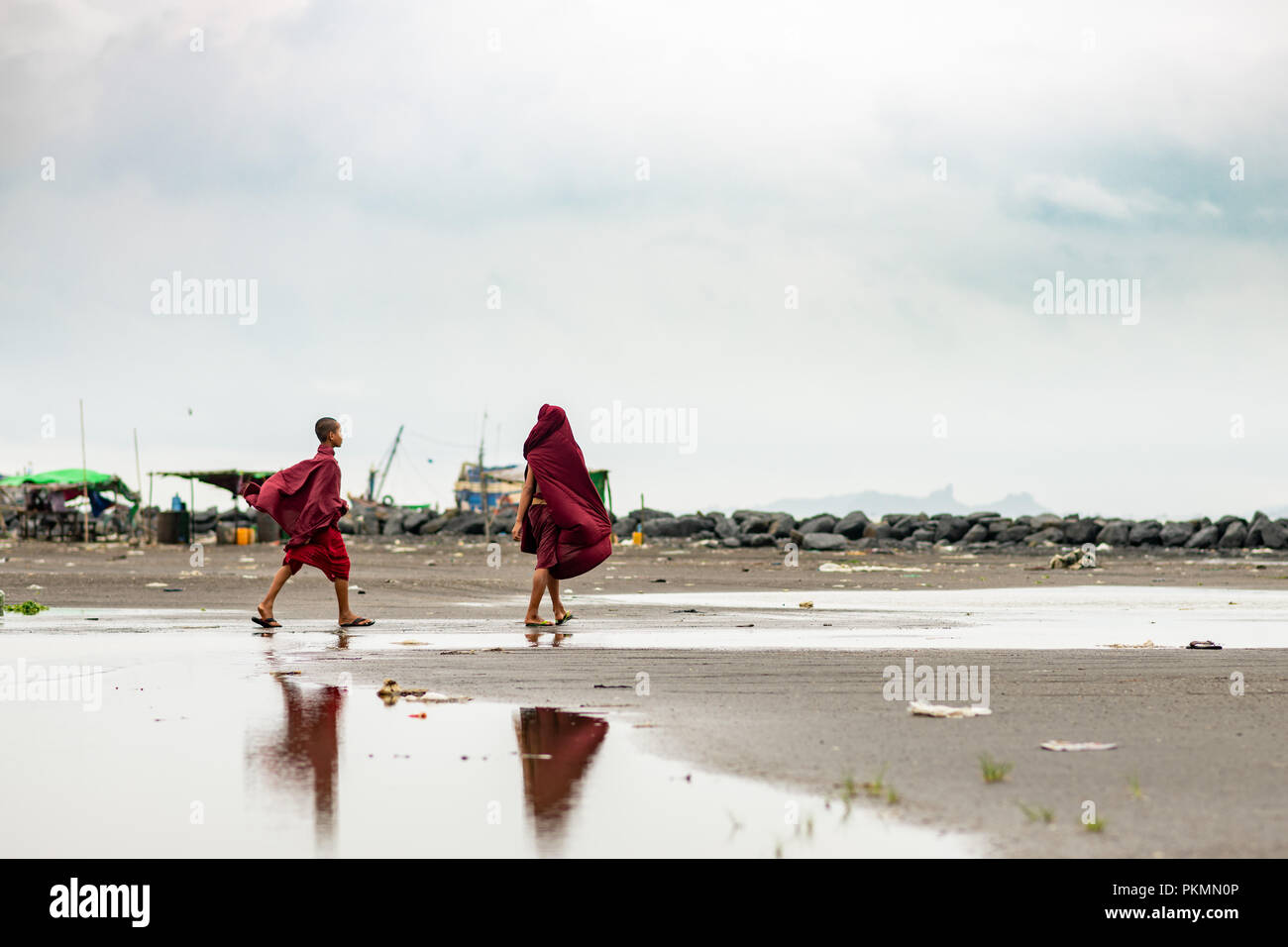 Sittwe, Myanmar. 5th Sep, 2018. After a storm, two monks walk along the ...