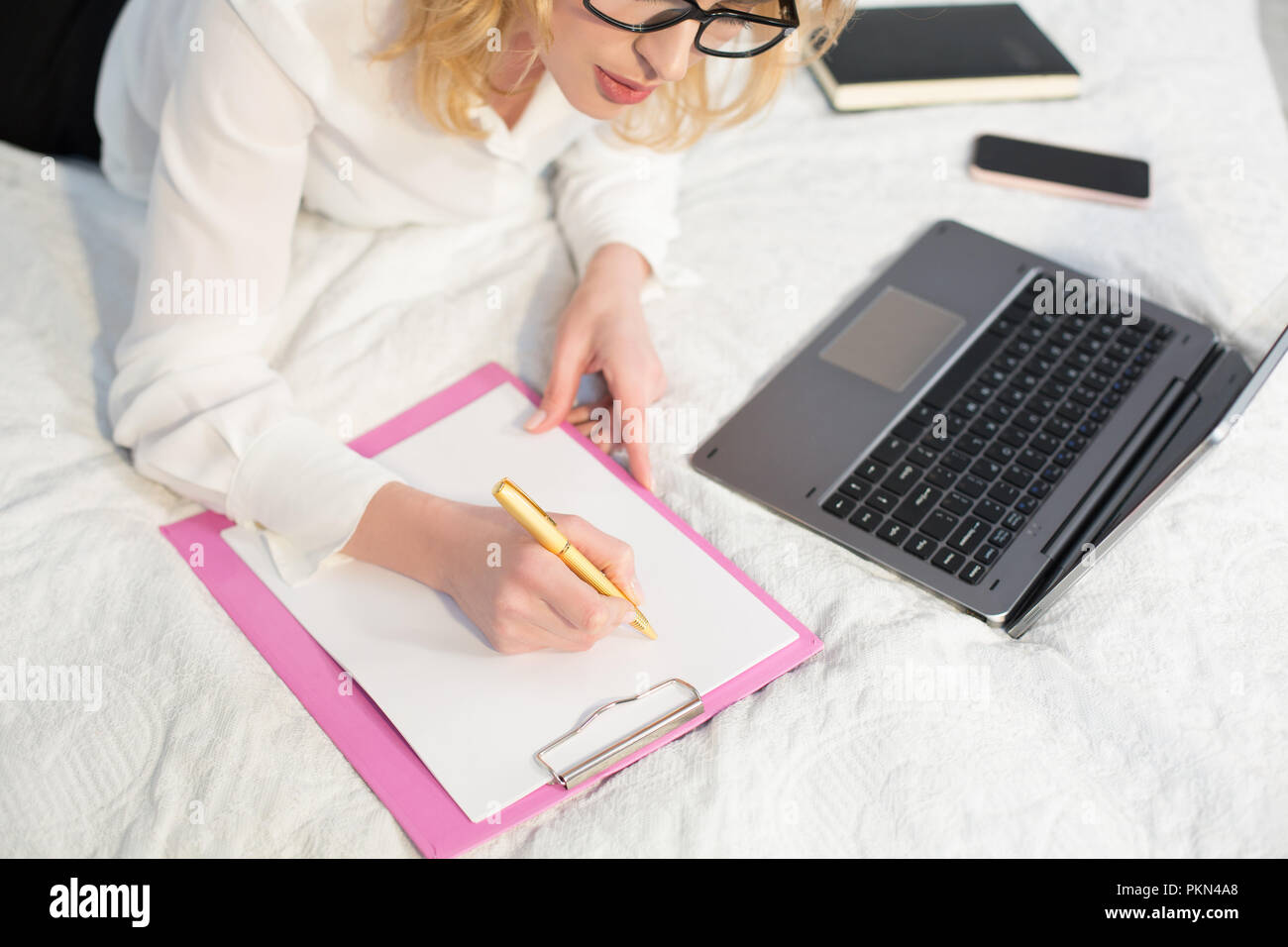 Businesswoman working laptop in bed Stock Photo - Alamy