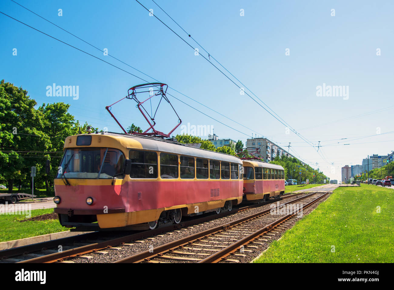 European city red tram move on street Stock Photo - Alamy