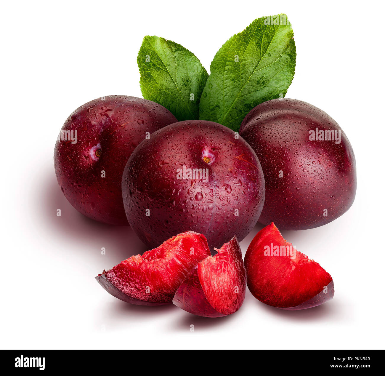 Appetizing and healthy red plums, whole and cut into segments with an ...