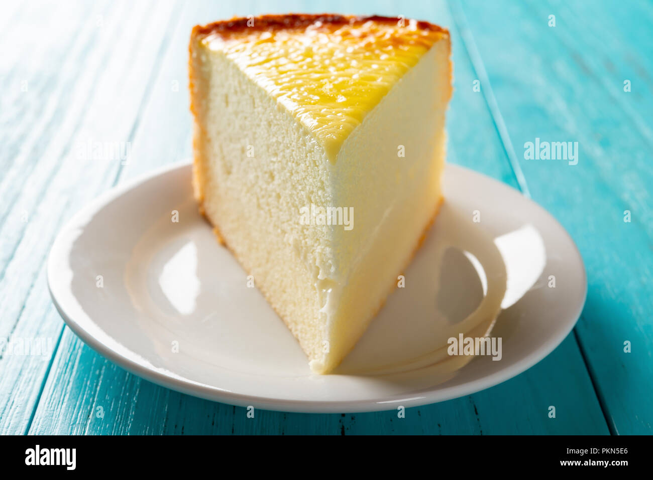 studio shoot of home made cheese cake on a blue table Stock Photo - Alamy