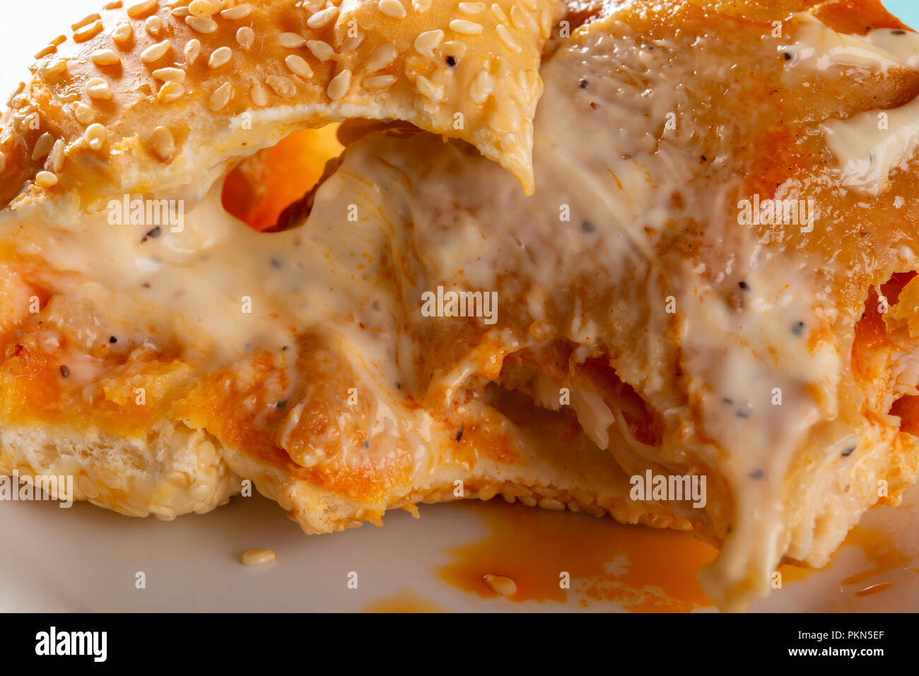 side view studio shot of bread with chicken with some bites close up ...