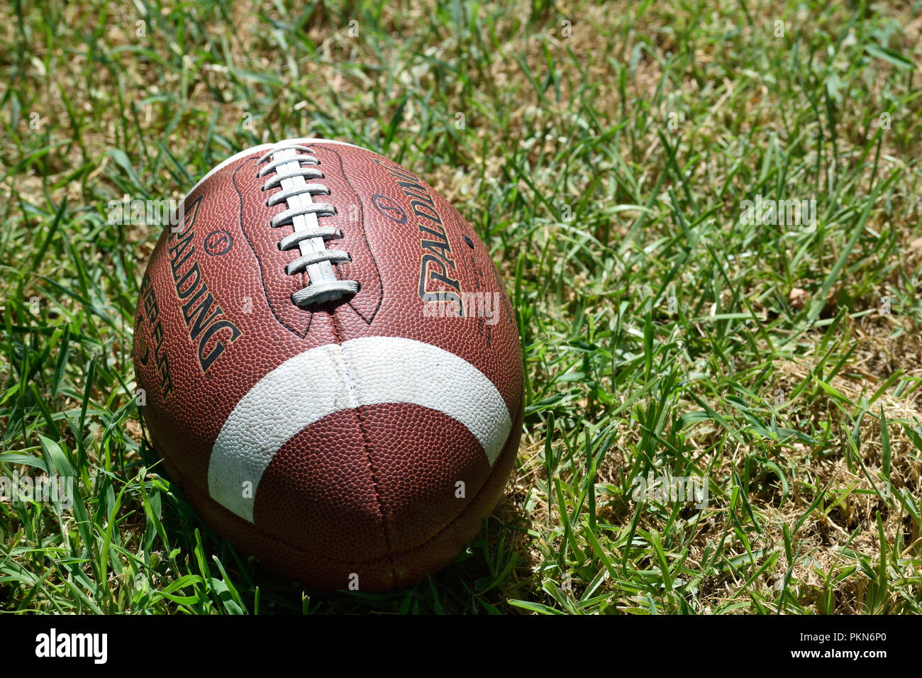 One Spalding football in a grass field Stock Photo - Alamy
